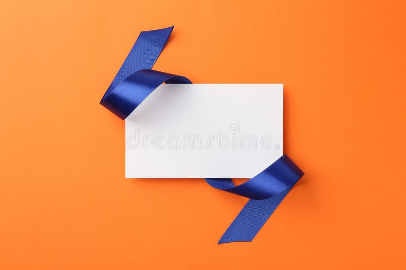 Blank Card and Blue Ribbon on Orange Background, Top View Stock Photo ...