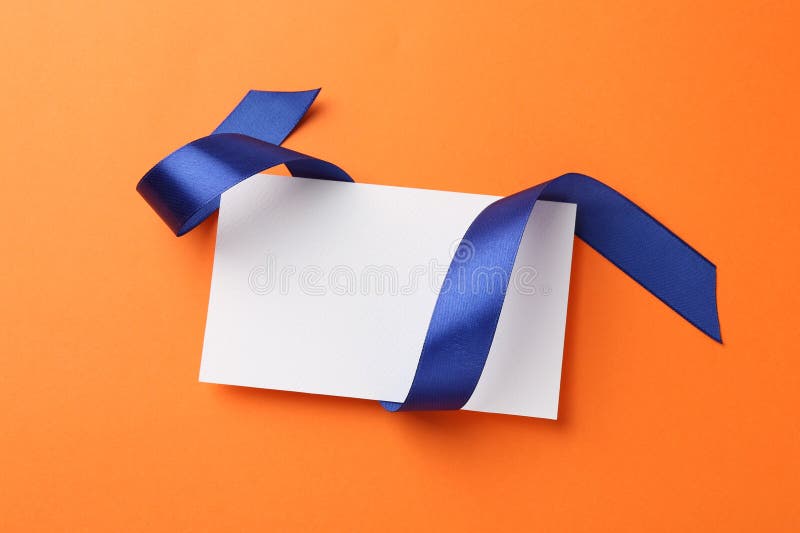 Blank Card and Blue Ribbon on Orange Background, Top View Stock Photo ...
