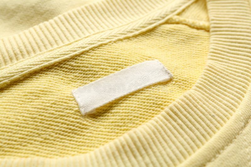Blank Clothing Label on Yellow Sweater, Closeup Stock Photo - Image of ...