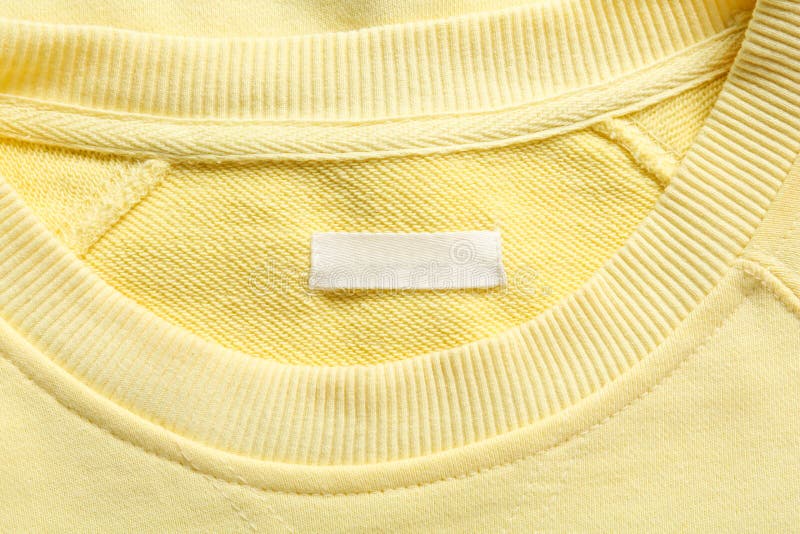Blank Clothing Label on Yellow Sweater, Top View Stock Photo - Image of ...