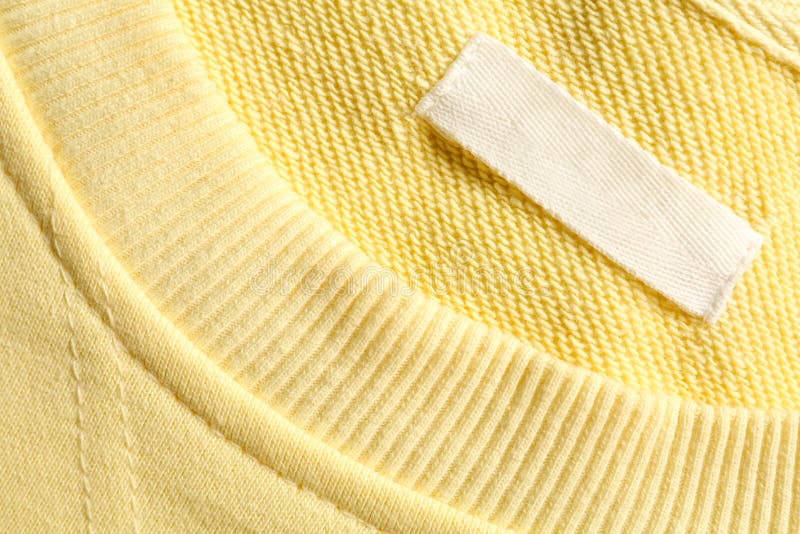 Blank Clothing Label on Yellow Sweater, Top View. Space for Text Stock ...