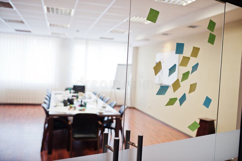 Blank Colored Sticky Note or Post Note Stuck on Glass Wall at Office ...