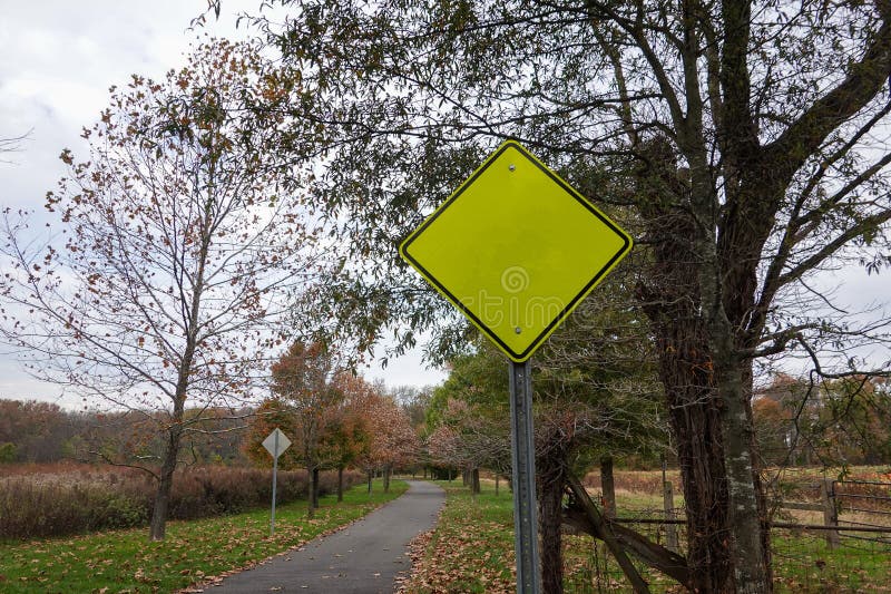 Blank Fluorescent Green Triangular Yield Sign Near a Country Walking ...
