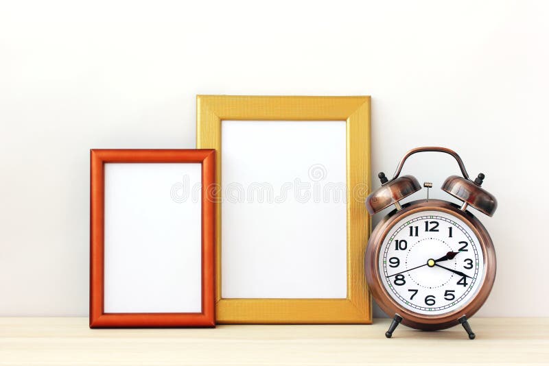 Empty Photo Frames and an Alarm Clock on a Light Background. Stock ...