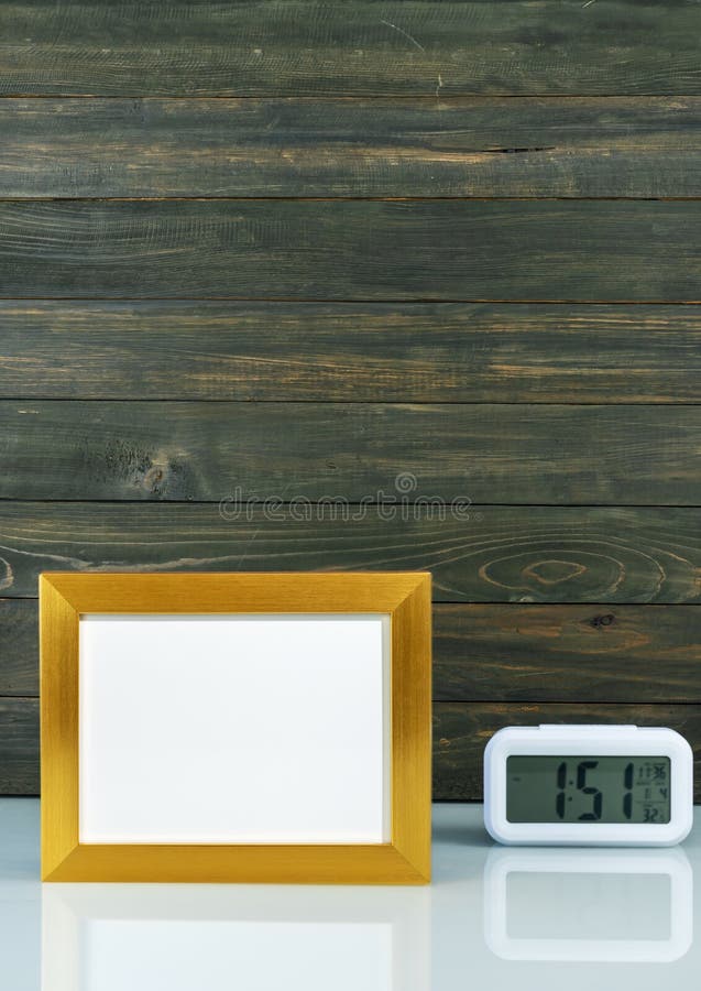 Blank Golden Frame and Digital Alarm Clock on Table Stock Image - Image ...