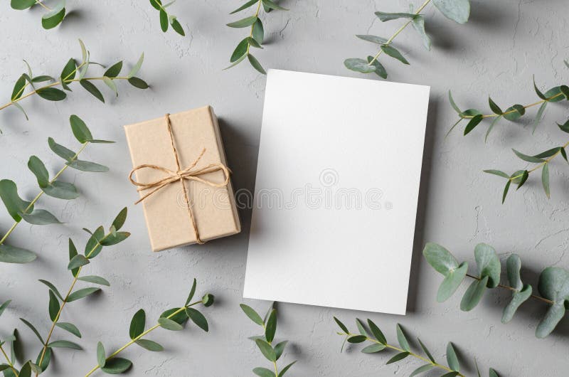 Blank Greeting Card Mockup with Gift and Green Eucalyptus Twigs Stock ...