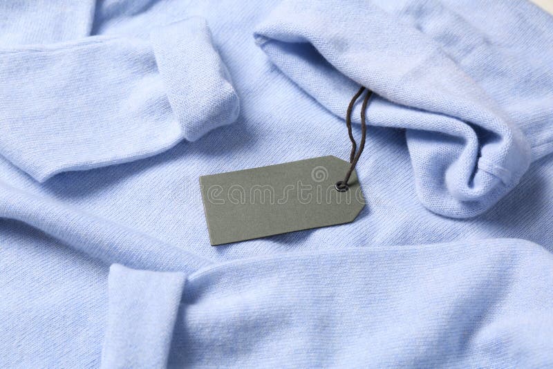 Blank Grey Tag on Light Blue Sweater. Space for Text Stock Image ...