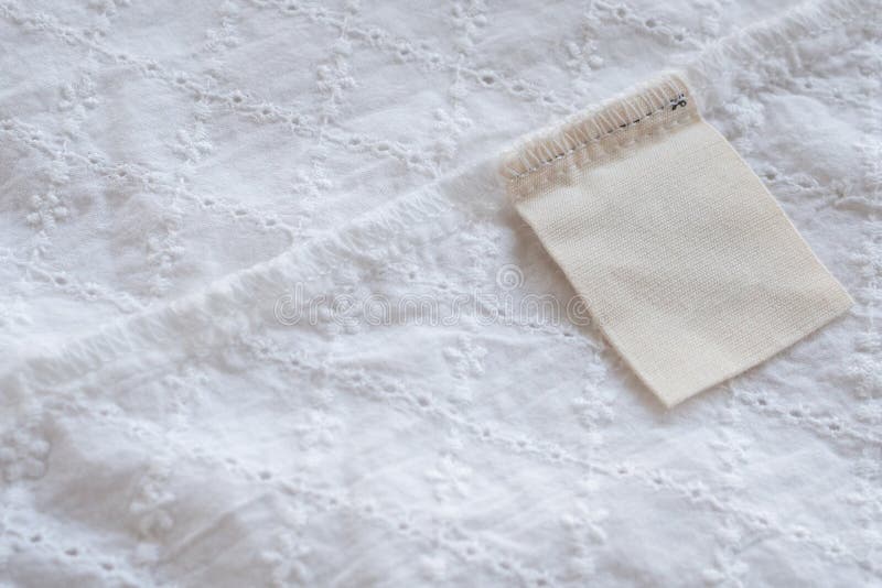 Blank Laundry Care Clothes Label on Fabric Texture Background Stock ...