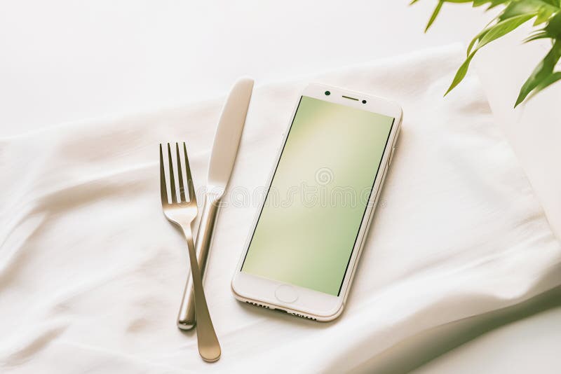Blank Mobile Mockup Screen on White Linen Tablecloth with Table Setting ...