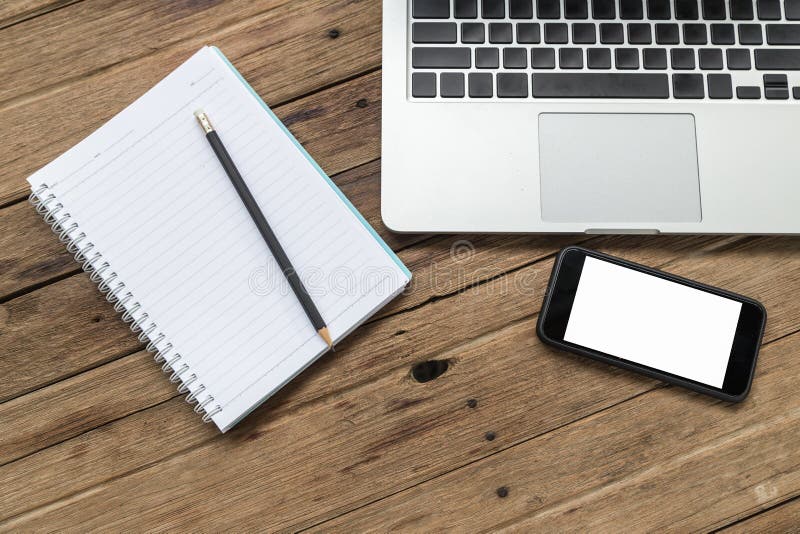 Blank Notepad, Mobile Phone and Laptop on Wood Table Stock Photo ...