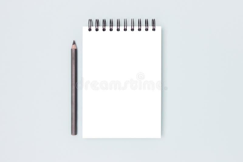 Blank Notepad Mock Up and Pencil on a Blue Background. Stock Photo ...