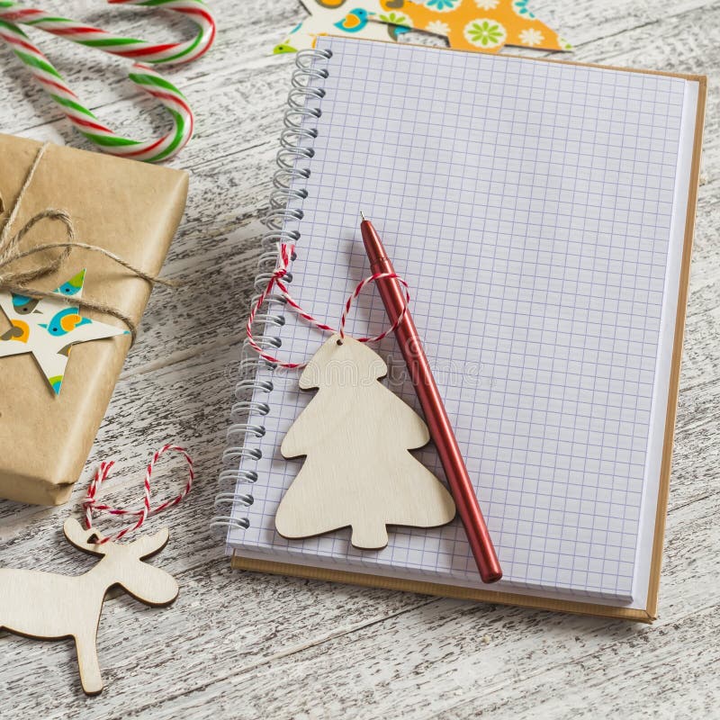 Blank Open Notepad, Christmas Gifts, Candies on a Wooden Surface Stock ...