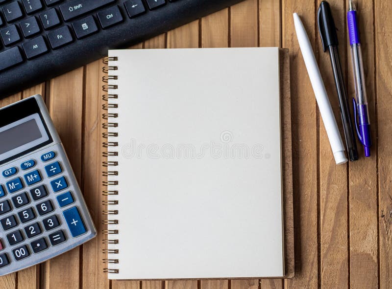 Blank Opened Spiral Notebook with a Calculator Keyboard Pens Placed ...