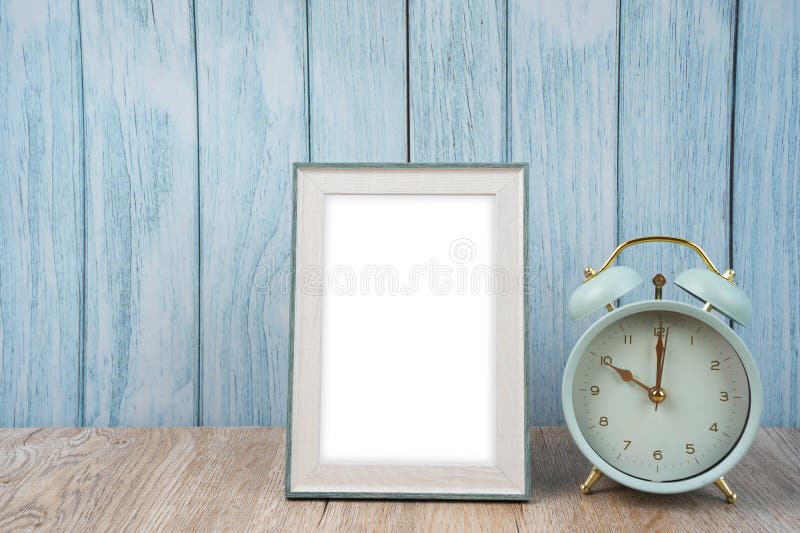 The Blank Picture Frame and Alarm Clock on Blue Floor with Copy Space ...