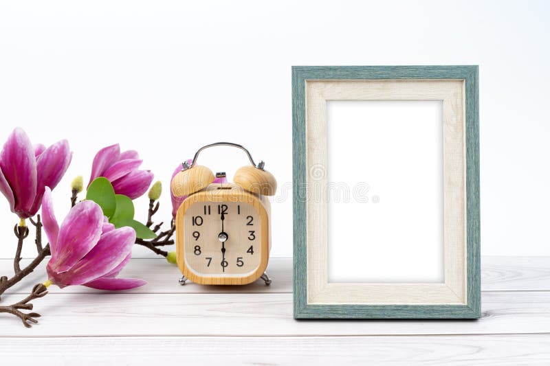 Blank Picture Frame and Alarm Clock on Wooden Floor with Copy Space ...