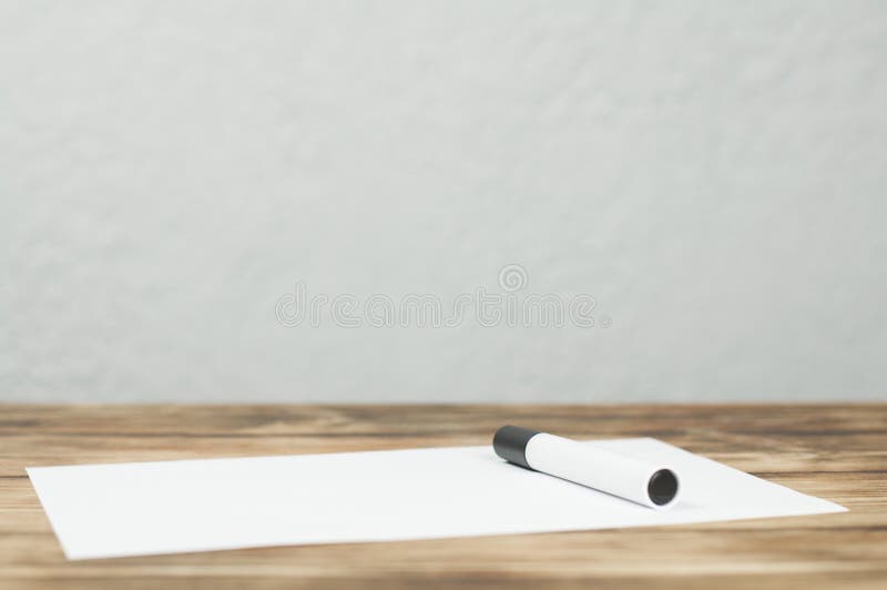 On the Table are a Marker, a Calculator and a Notebook with the ...