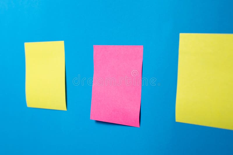 Three Blank Sticky Notes on Blue Wall at Angle Stock Photo - Image of ...
