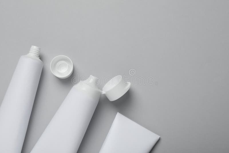 Blank Tubes of Toothpaste on Light Grey Background, Flat Lay. Space for ...