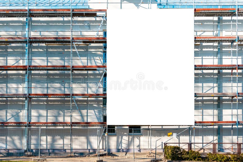 Blank White Advertisement Hanging on the Scaffolding of Modern Building ...