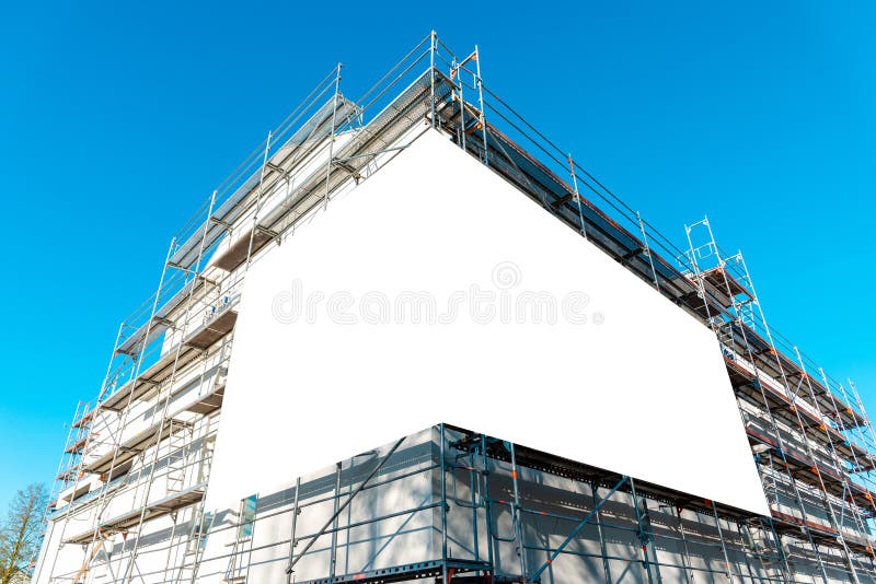 Blank White Advertisement Hanging on the Scaffolding of Modern Building ...