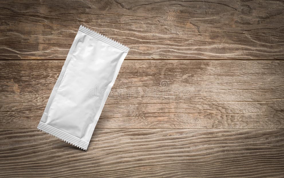 Blank White Condiment Packet Floating on Aged Wood Background Stock ...