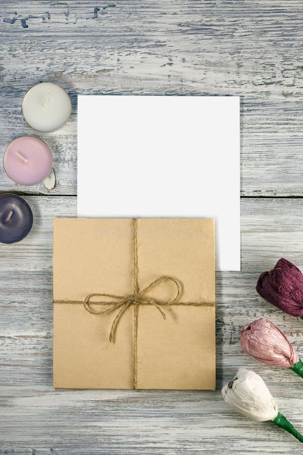 Blank White Greeting Card and Envelope with Candles and Flowers Over ...