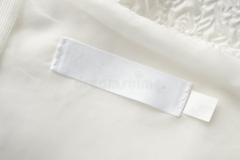 Blank White Laundry Care Clothes Label on Fabric Texture Background ...