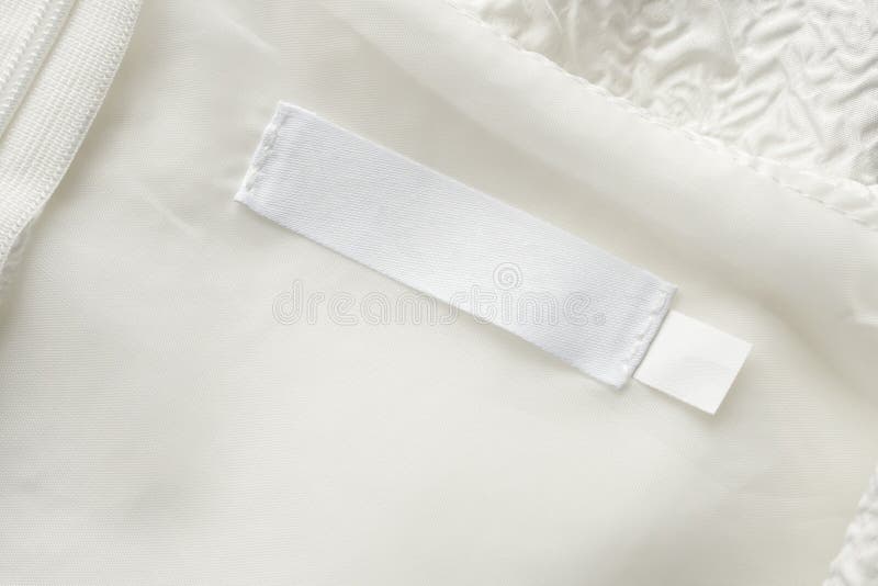 Blank White Laundry Care Clothes Label on Fabric Texture Background ...