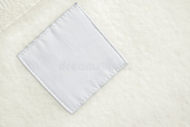 Blank White Laundry Care Clothes Label on Fabric Texture Background ...