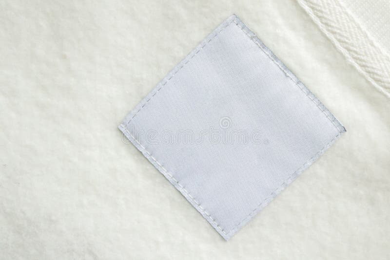 Blank White Laundry Care Clothes Label on Fabric Texture Background ...