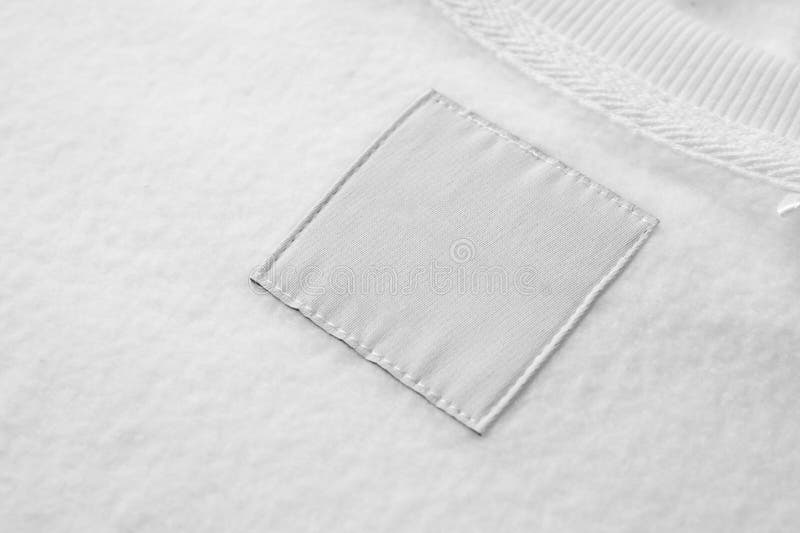 Blank White Laundry Care Clothes Label on Fabric Texture Stock Photo ...