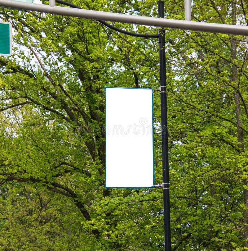 Two Blank Vertical White Signs on a Pole in Front of a Stone Building ...