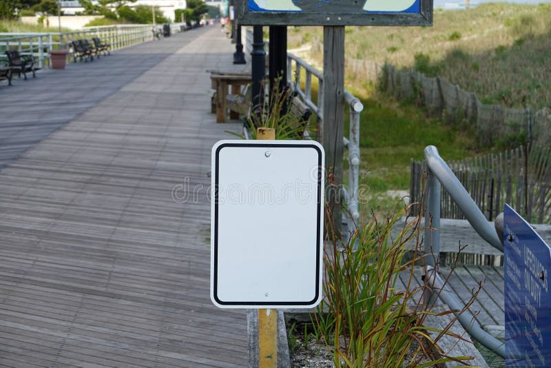 A Blank White Sign with Black Border on a Wooden Boardwalk Stock Photo ...