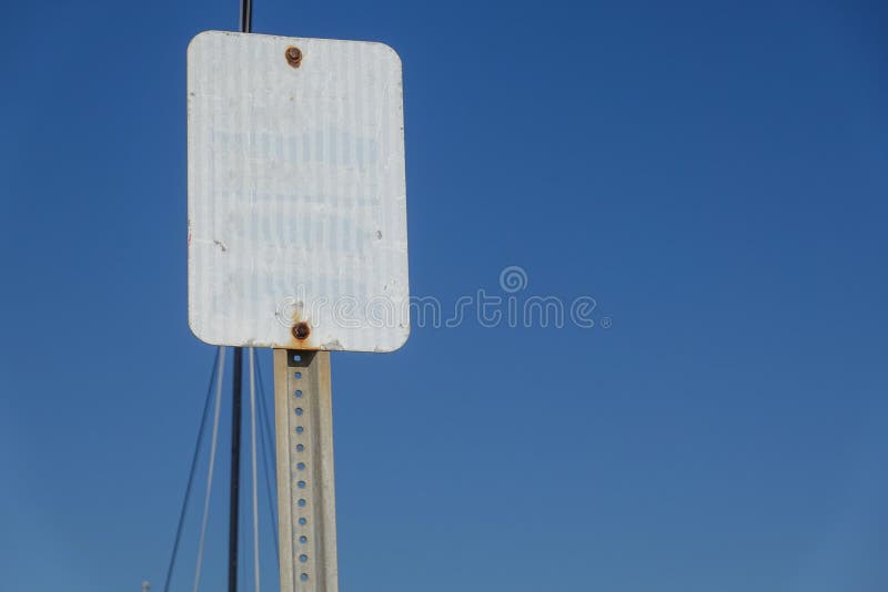 Blank White Sign on a Metal Post Against a Clear Cloudless Blue Sky ...