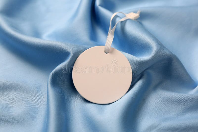 Blank White Tag on Light Blue Silky Fabric, Closeup. Space for Text ...