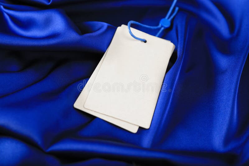 Blank White Tags on Blue Silky Fabric, Closeup. Space for Text Stock ...