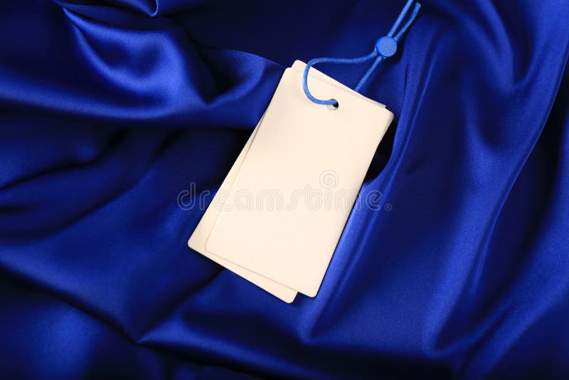 Blank White Tags on Blue Silky Fabric, Top View. Space for Text Stock ...