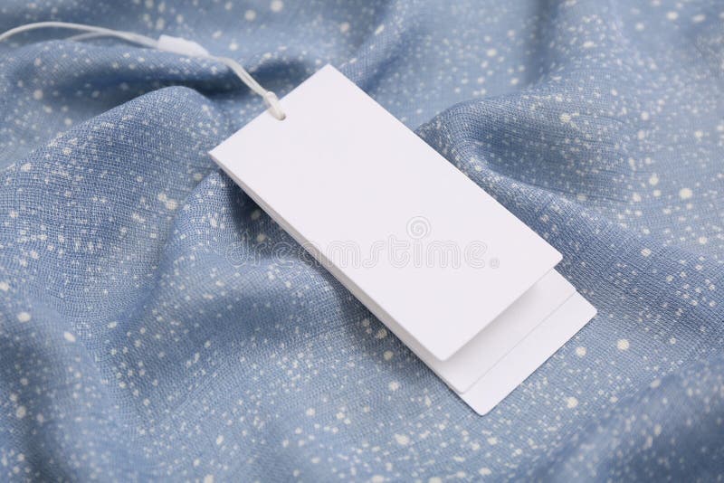 Blank White Tags on Light Blue Fabric, Closeup. Space for Text Stock ...