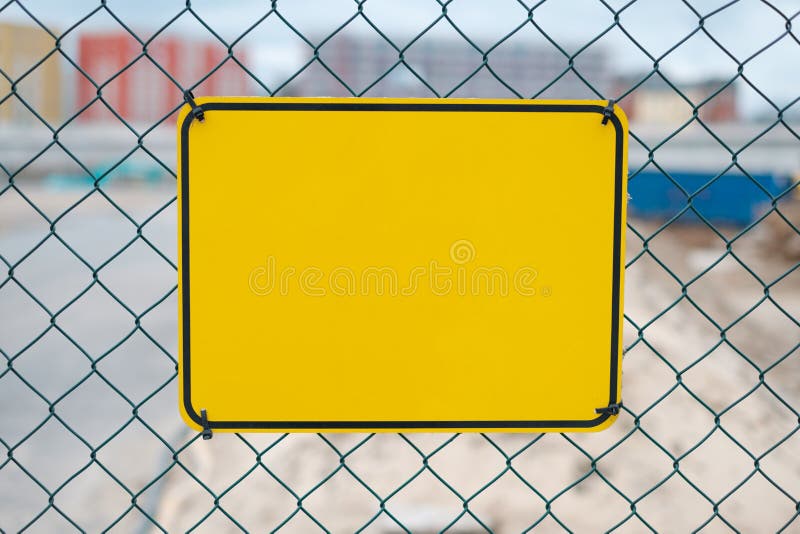 Blank Yellow Sign on Construction Site Fence - Warning Sign Mockup ...