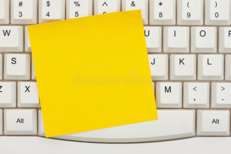 Blank Yellow Sticky Note on a Gray Computer Keyboard Stock Photo ...