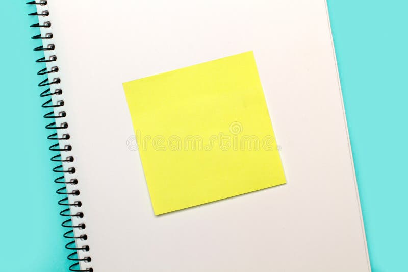Blank Yellow Sticky Paper on a Blank Page of a Notepad on a Light Blue ...
