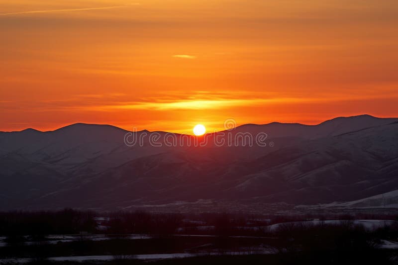 Blazing Winter Solstice Sunset Behind Silhouetted Hills Stock ...