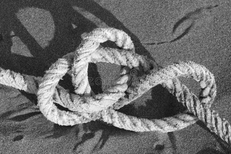 Knot of thick rope on sand stock image. Image of nautical - 199719083