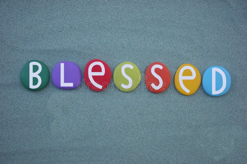 Blessed Word Composed with Multi Colored Stone Letters Over Green Sand ...