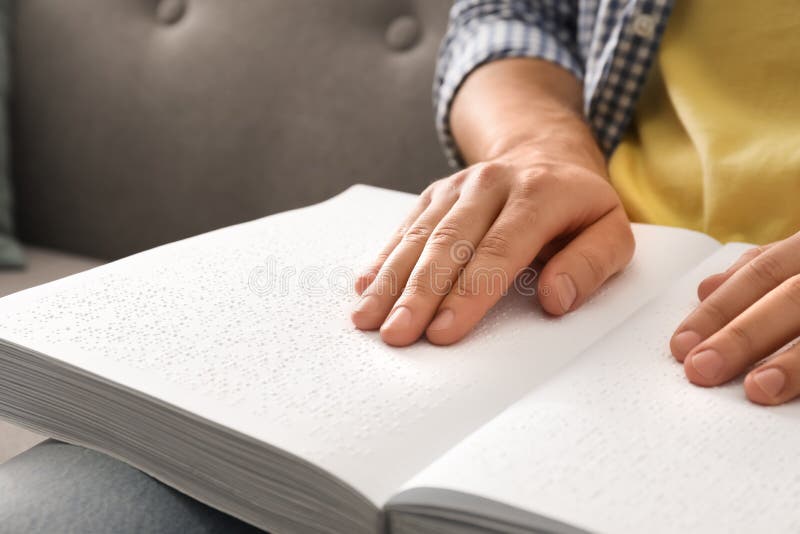 Blind Man Reading Book Written in Braille on Sofa Stock Image - Image ...