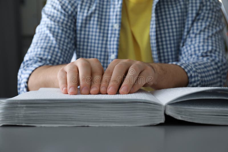 Blind Man Reading Book Written in Braille at Table Stock Image - Image ...