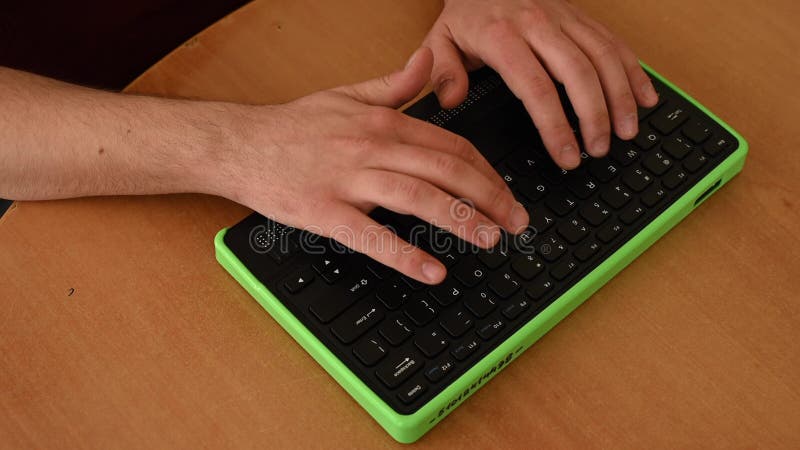 A Blind Man Uses a Computer with a Braille Display and a Computer ...
