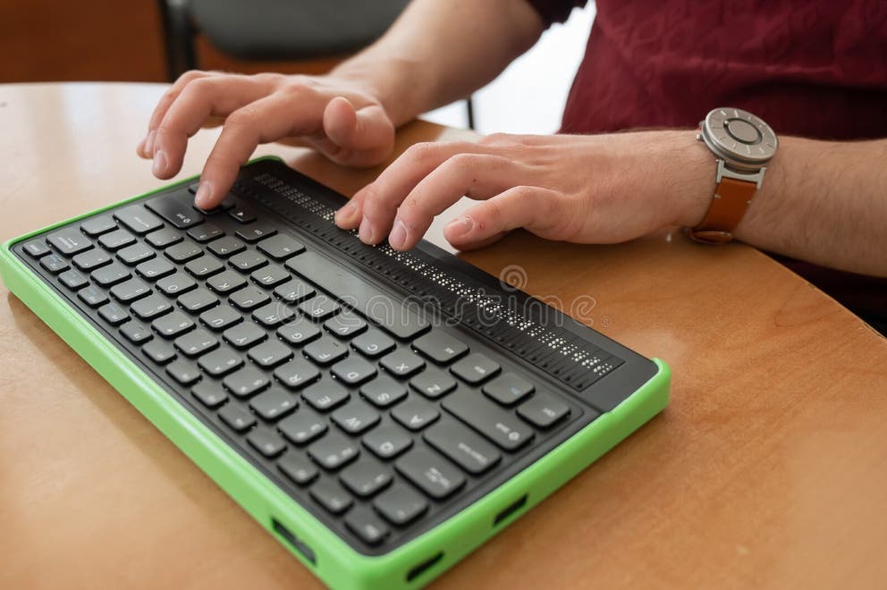 A Blind Man Uses a Computer with a Braille Display and a Computer ...