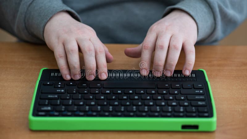 A Blind Man Uses a Computer with a Braille Display and a Computer ...