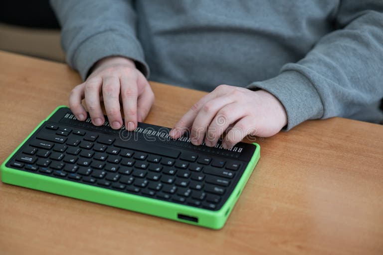 A Blind Man Uses a Computer with a Braille Display and a Computer ...